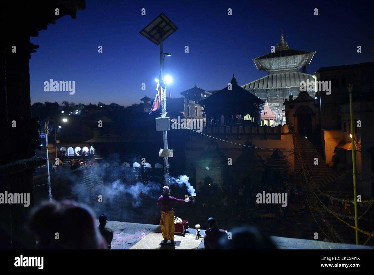 A Nepalese young priest or pundit perform evening Aarti (Hindu ...