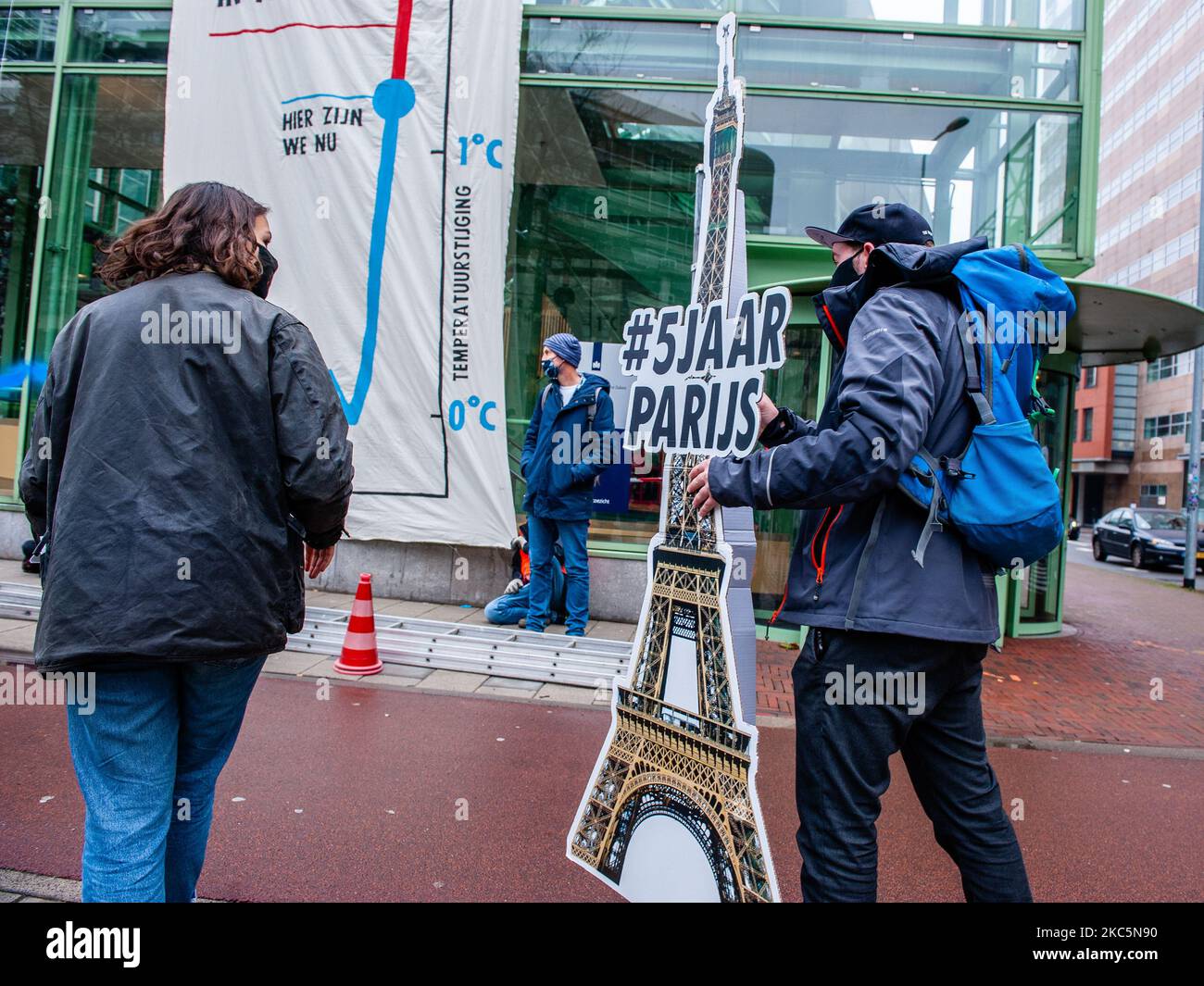 An Activist Is Carrying A Eiffel Placard To Remember The Paris Climate
