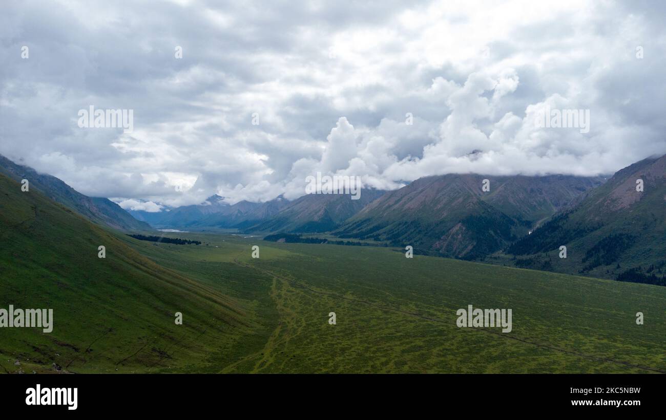 A gorgeous view of massive green hills during a cloudy day Stock Photo ...