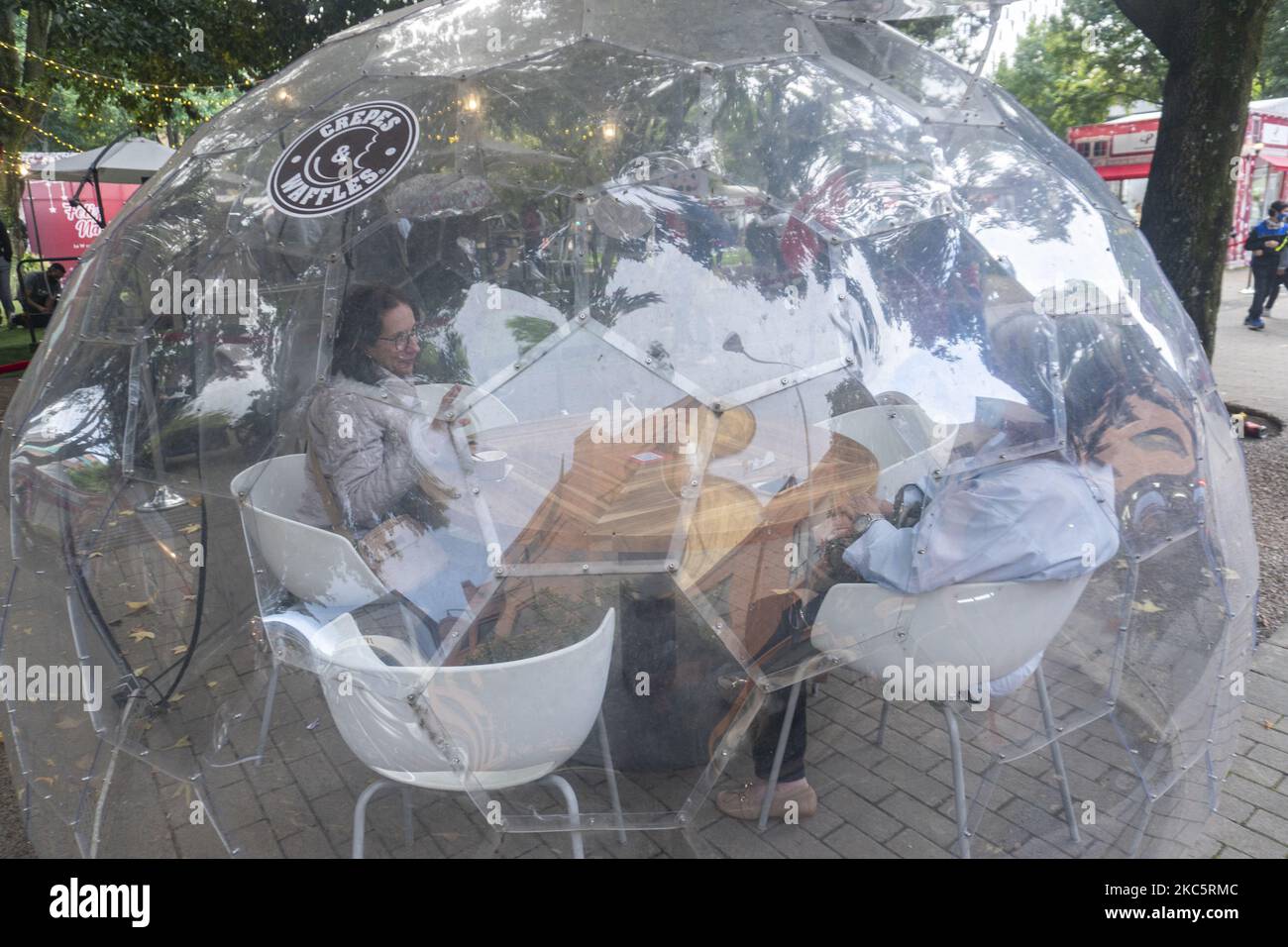 A family eats lunch in a capsule as a protection and biosecurity ...