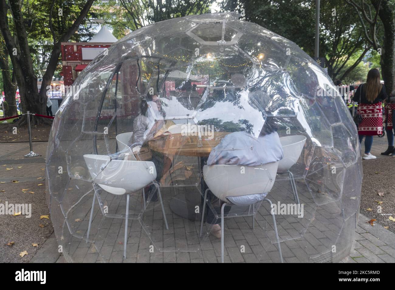 A family eats lunch in a capsule as a protection and biosecurity ...