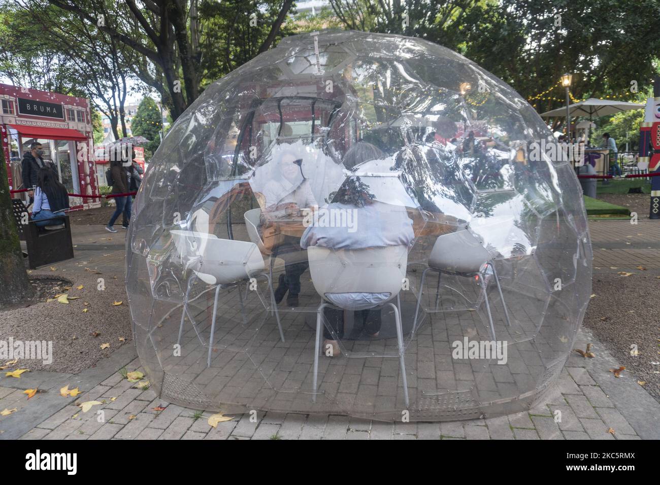 A family eats lunch in a capsule as a protection and biosecurity ...