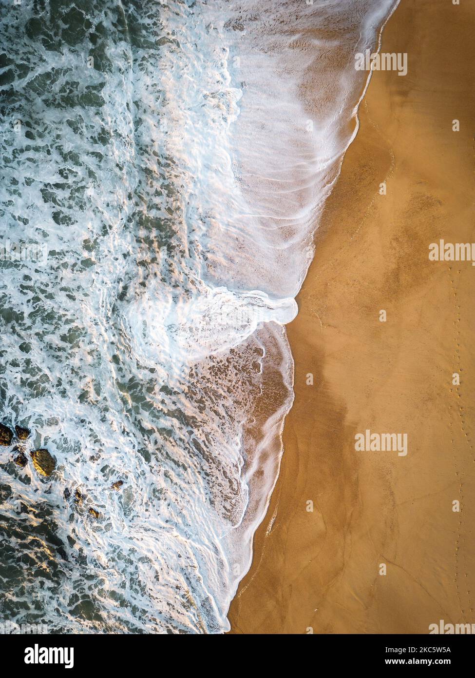 Aerial views of crashing waves at the beach Stock Photo - Alamy