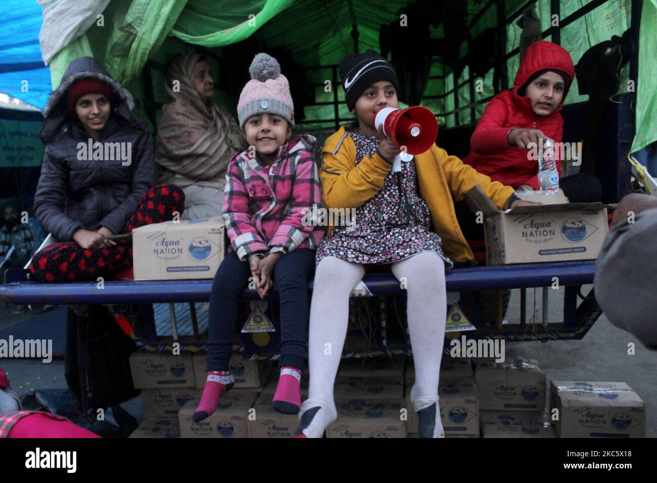 Children shout slogans as they participate along with their parents, at ...