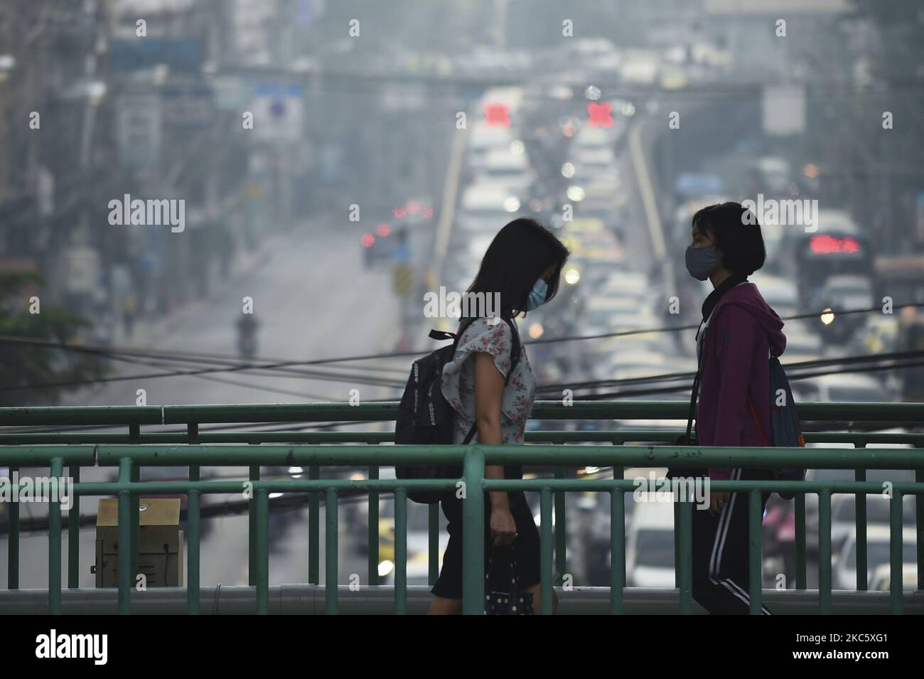 People wear face masks on a hazy day in Bangkok, Thailand, 15 December ...