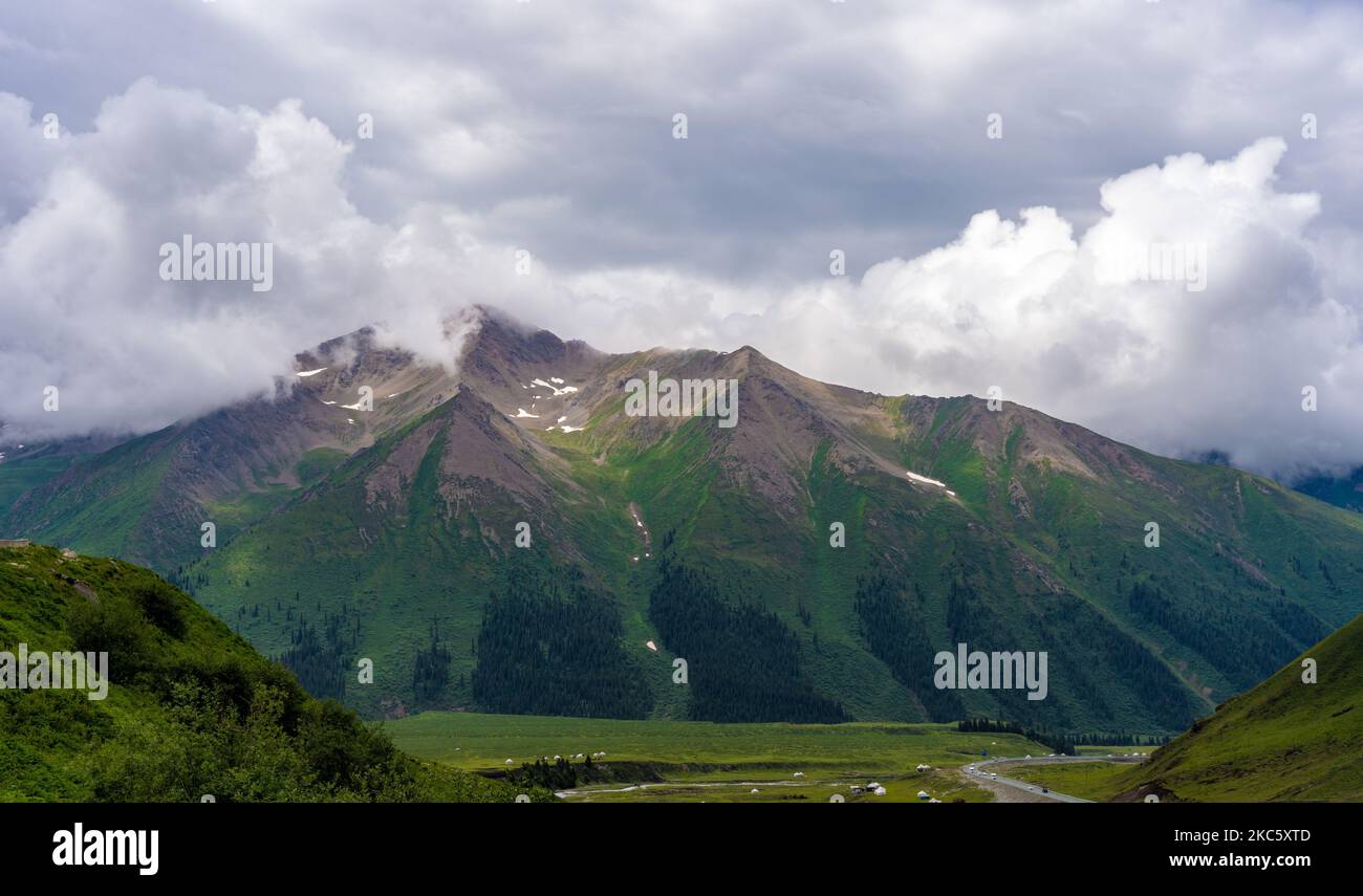 A gorgeous view of massive green hills during a cloudy day Stock Photo ...