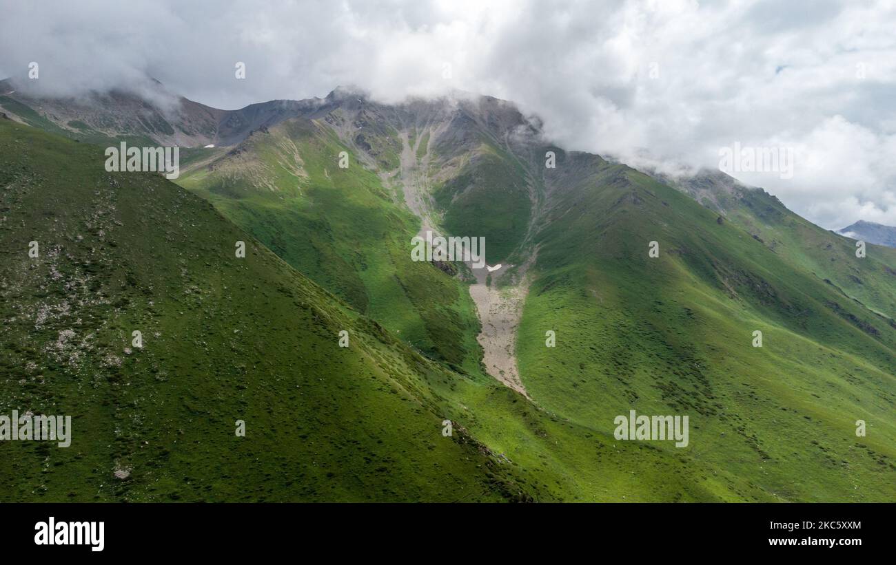 A gorgeous view of massive green hills during a cloudy day Stock Photo ...