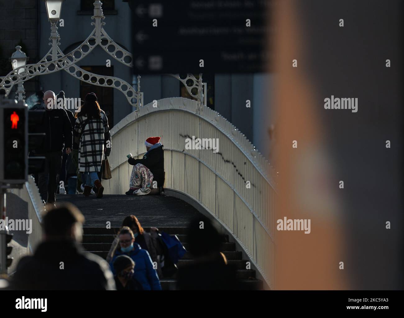 A beggar seen on the Ha'penny bridge in the center of Dublin. As per ...