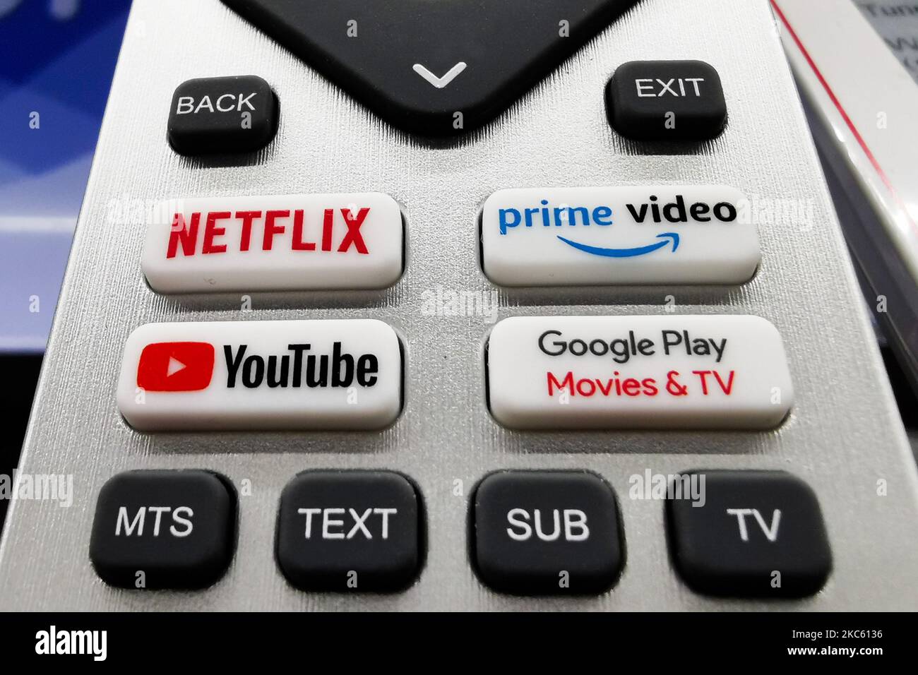 A detail of TV remote control with streaming platform buttons is seen ...