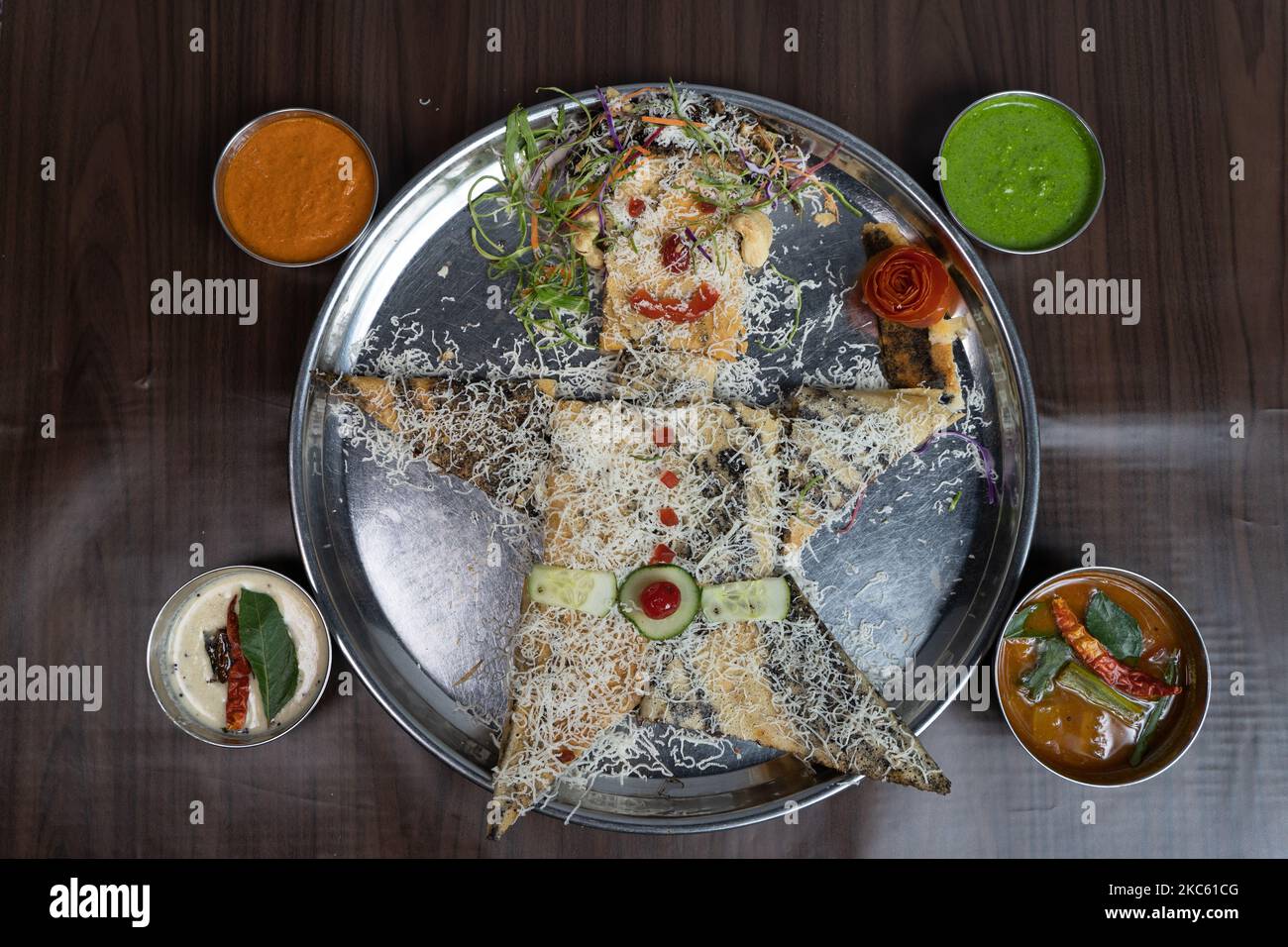 A top view of delicious Indian Dosa in form of a cute human with ...