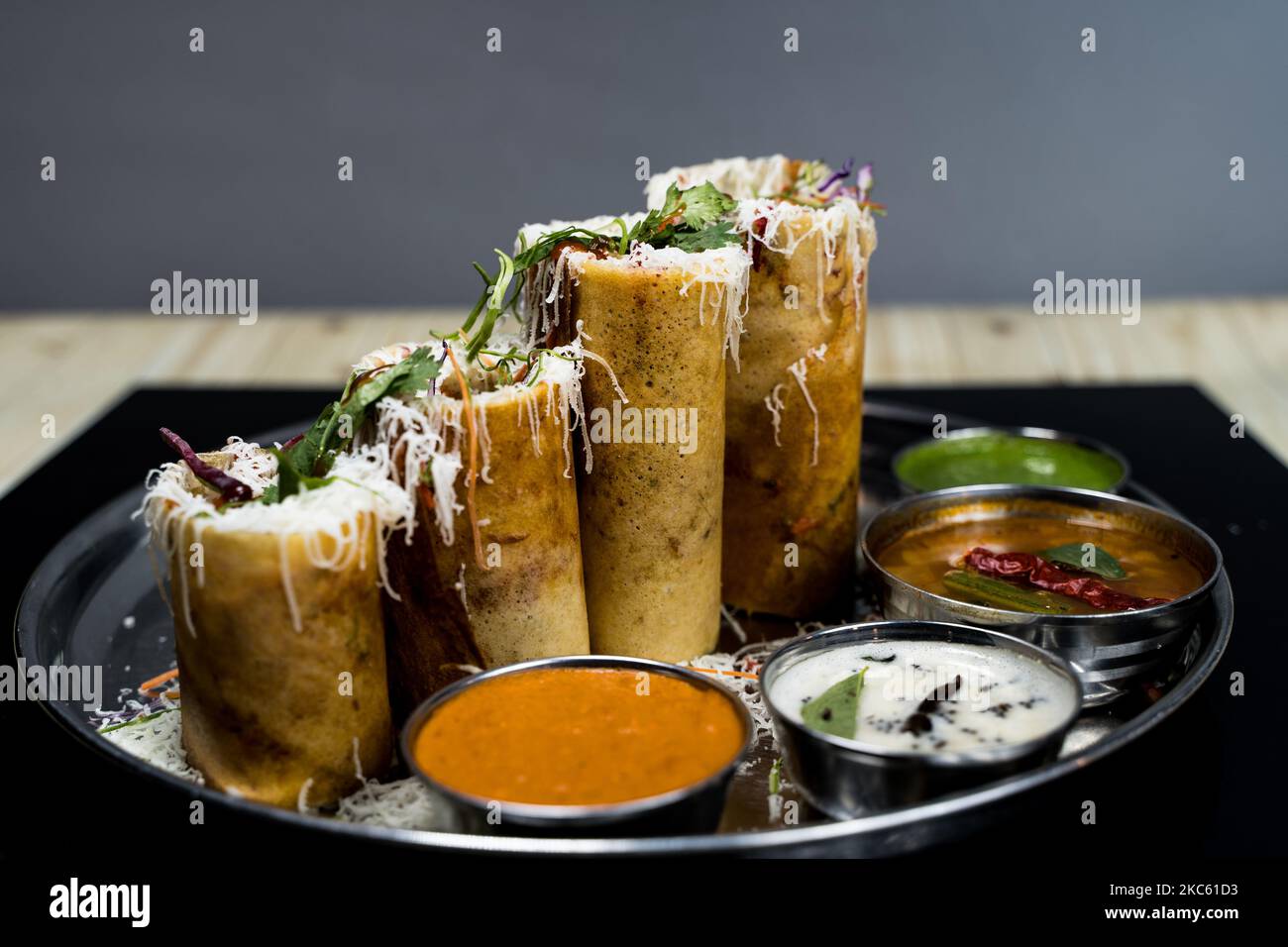 A plate full of delicious Indian Dosa wraps with chutney sauces Stock ...