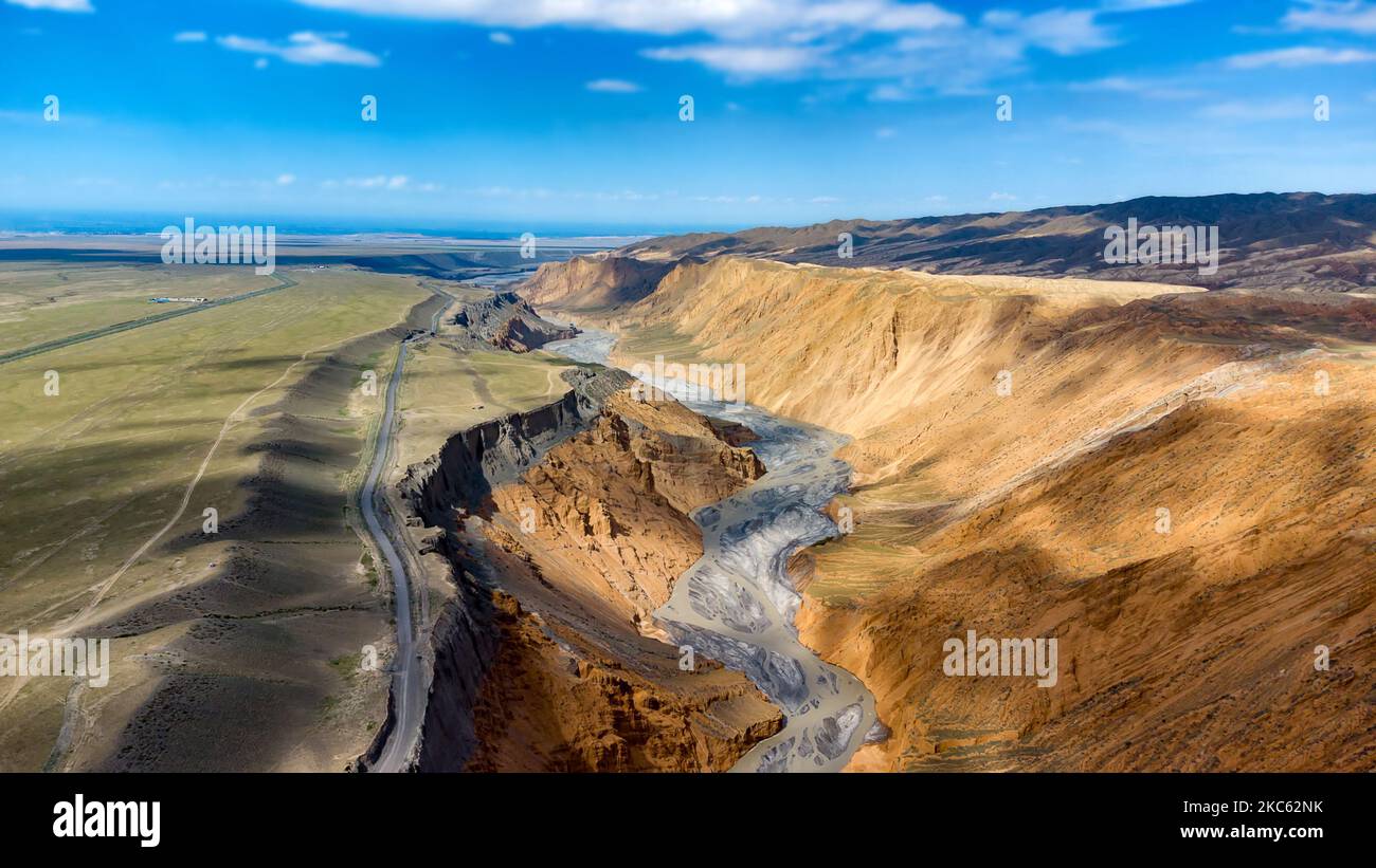 A road along the river going through mountains and cliffs, aerial Stock ...