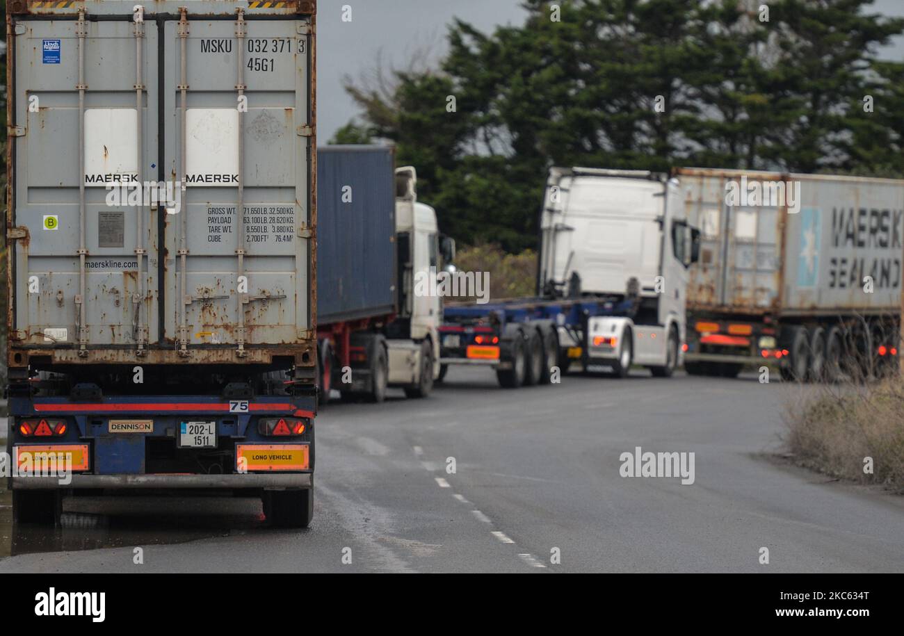 A line of container tracks waiting to load or unload outside a ...