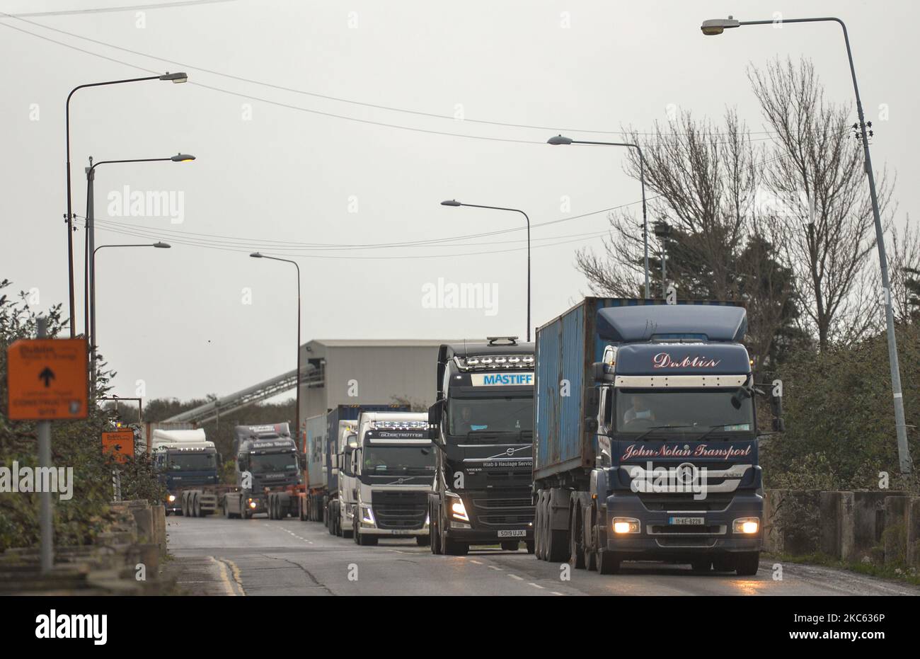 A line of container tracks waiting to load or unload outside a ...