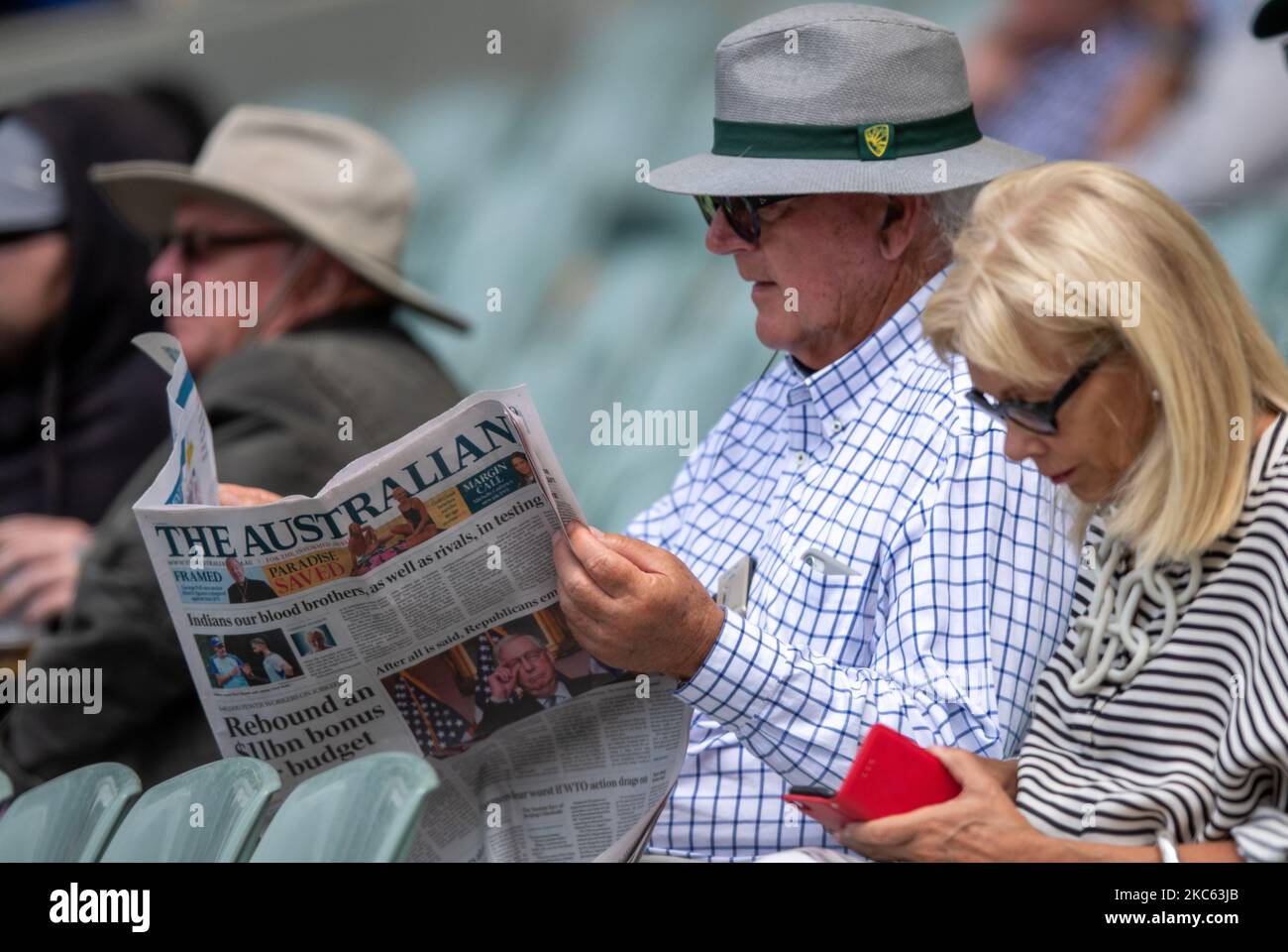 A spectator reads the newspaper during day one of the First Test match ...