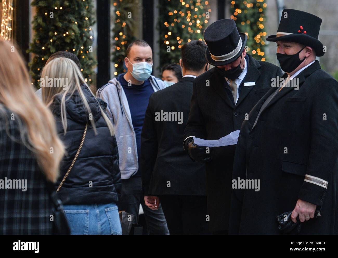 Two greeters wearing face masks seen filtering customers at the ...
