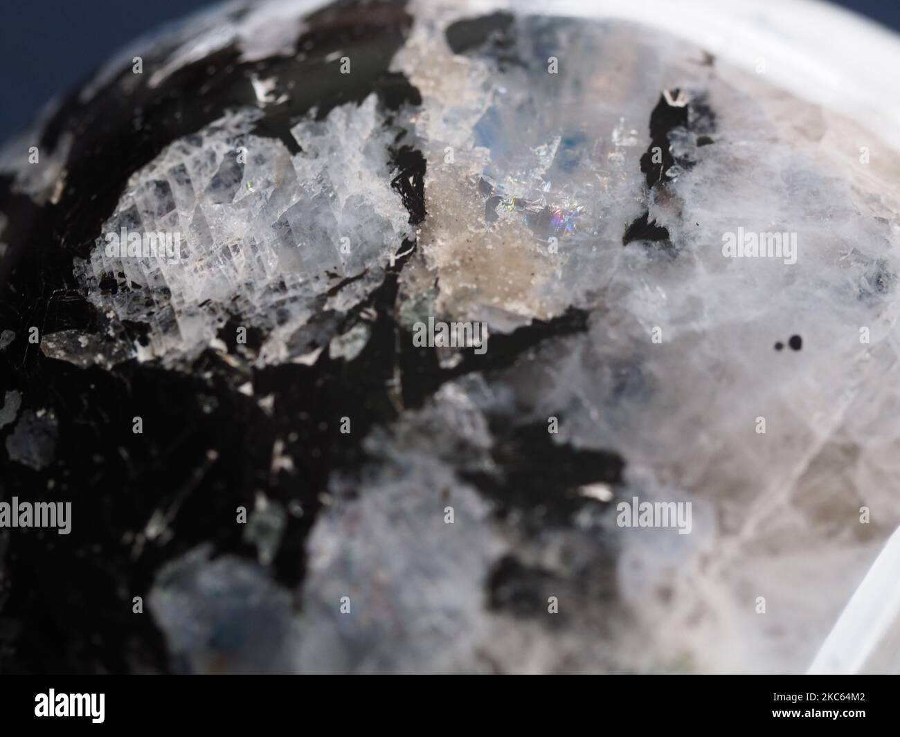 Moonstone with Black and Rainbow Inclusions Stock Photo - Alamy