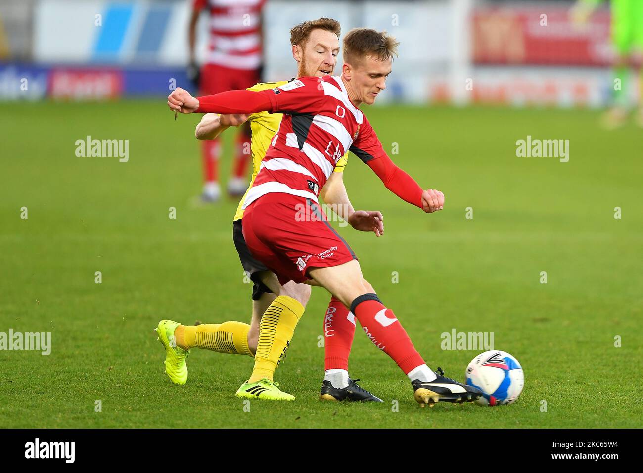 Matt Smith of Doncaster Rovers battles with Stephen Quinn of Burton ...