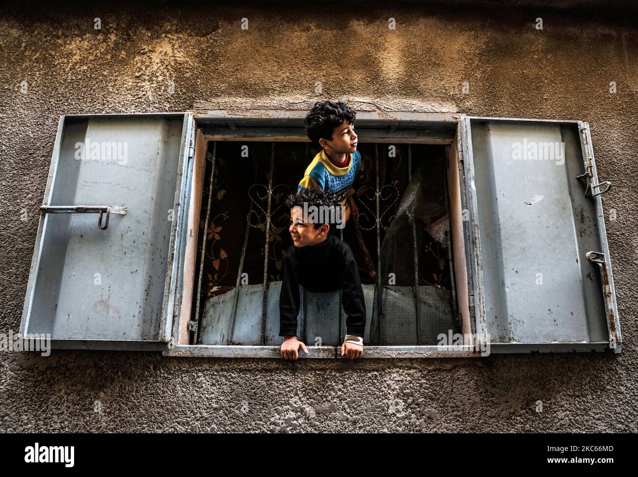 Palestinian ;children ;look; out ;their; family's; home ;window ;Gaza ...