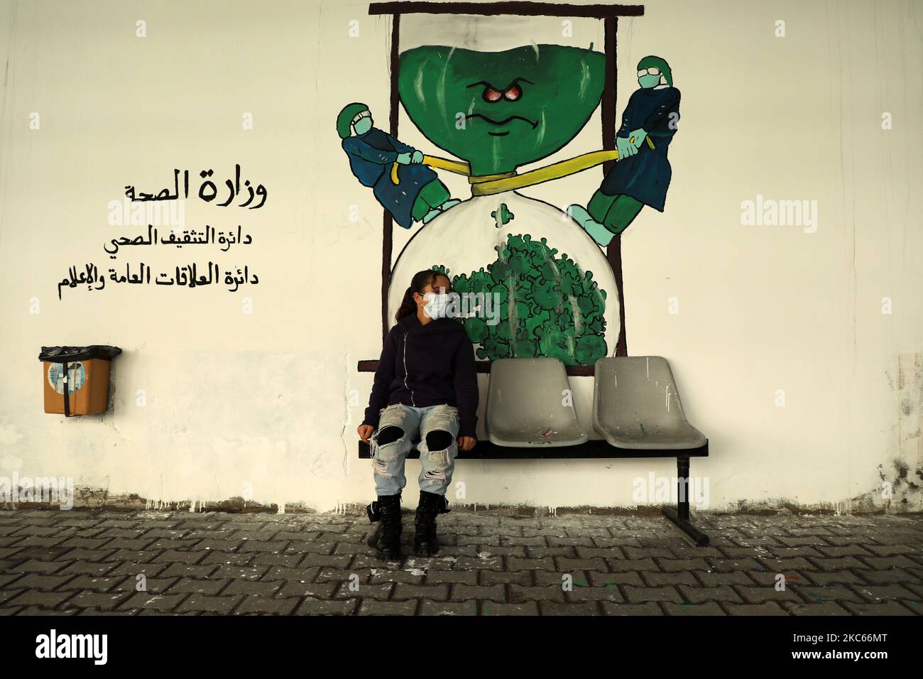 A Palestinian child sits beneath graffiti depicting medical workers ...