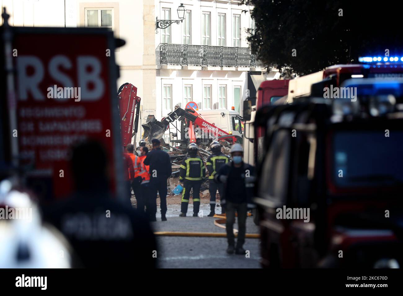 Firefighters, rescue and medical personnel are seen at work on the ...