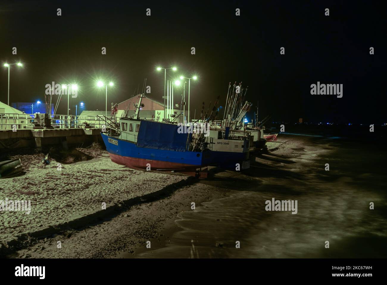 Fishing boats on the beach in te night sceney are seen in Mechelinki ...