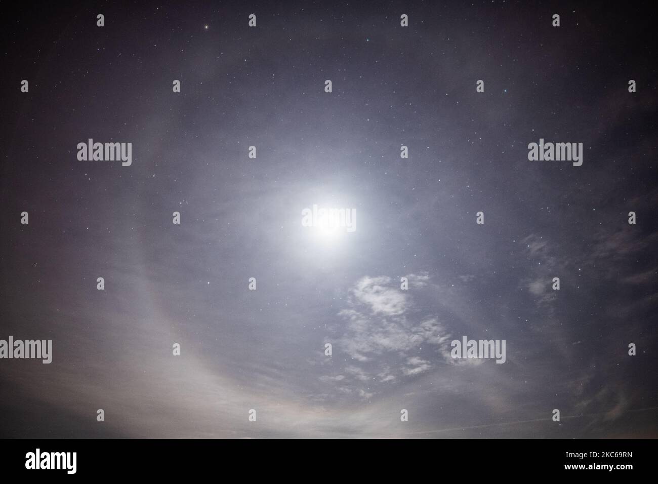 An ice crystal halo (22° halo phenomenon) around the Moon in L'Aquila ...