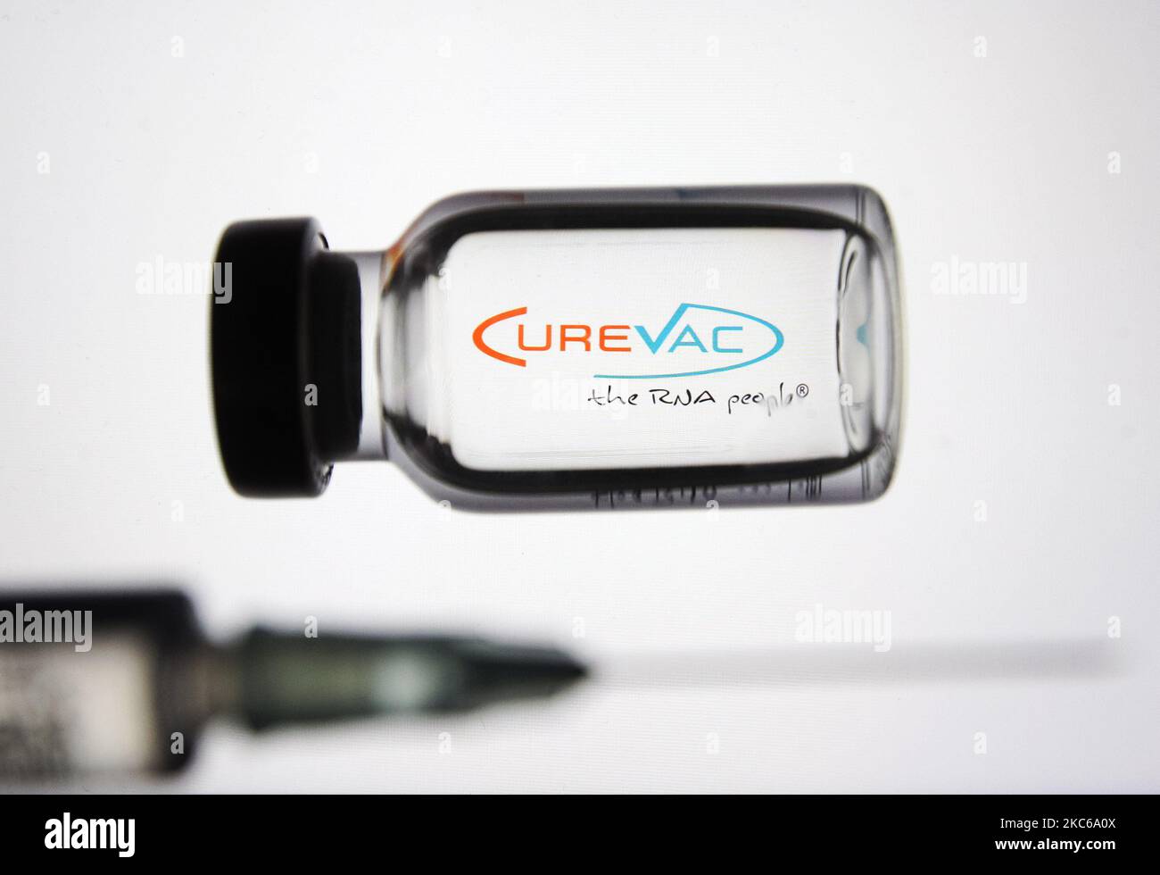 A medical syringe and a vial are seen in front of CureVac ...