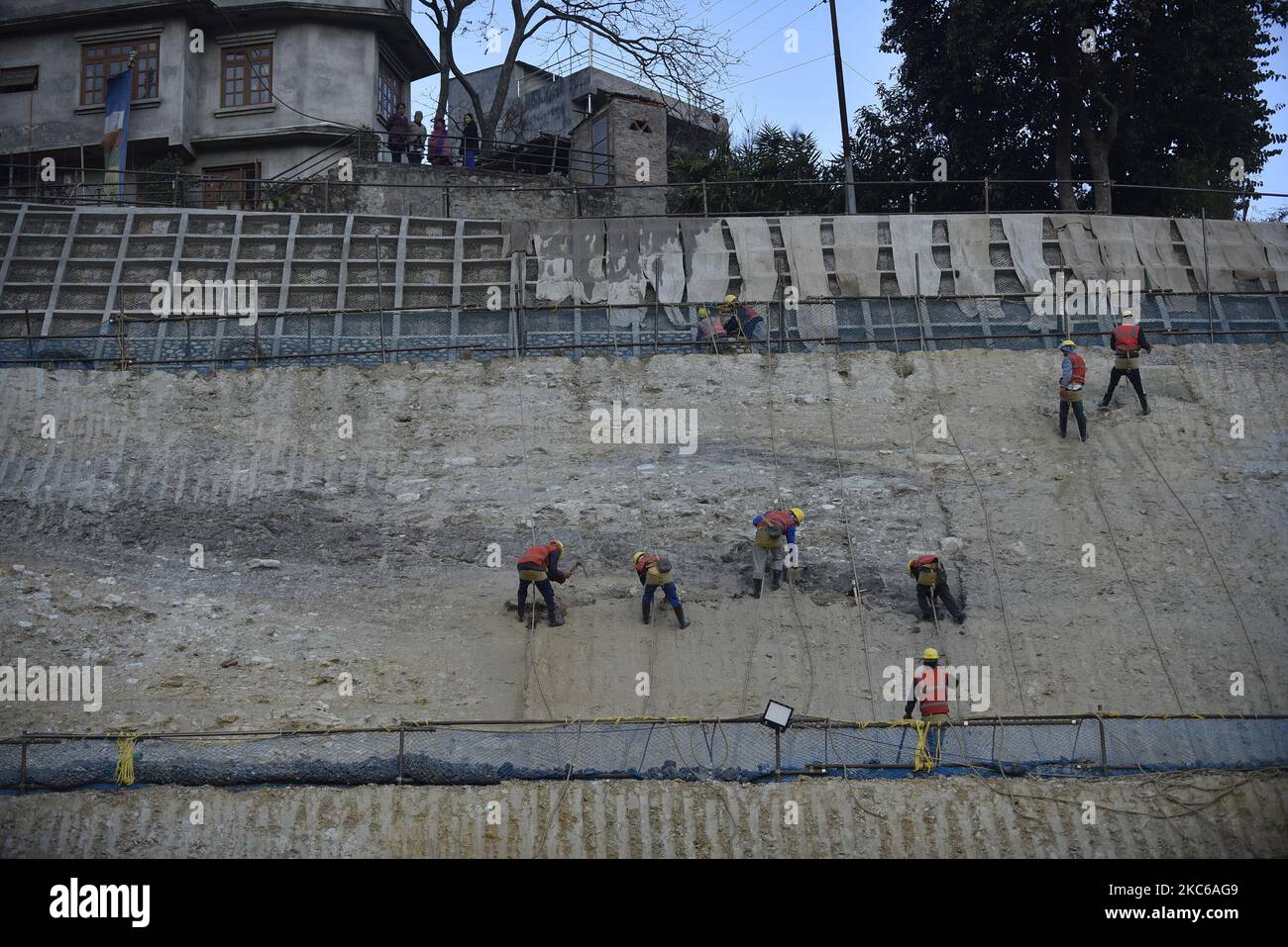 Nepalese workers working at the excavation site of Nepal's first road ...