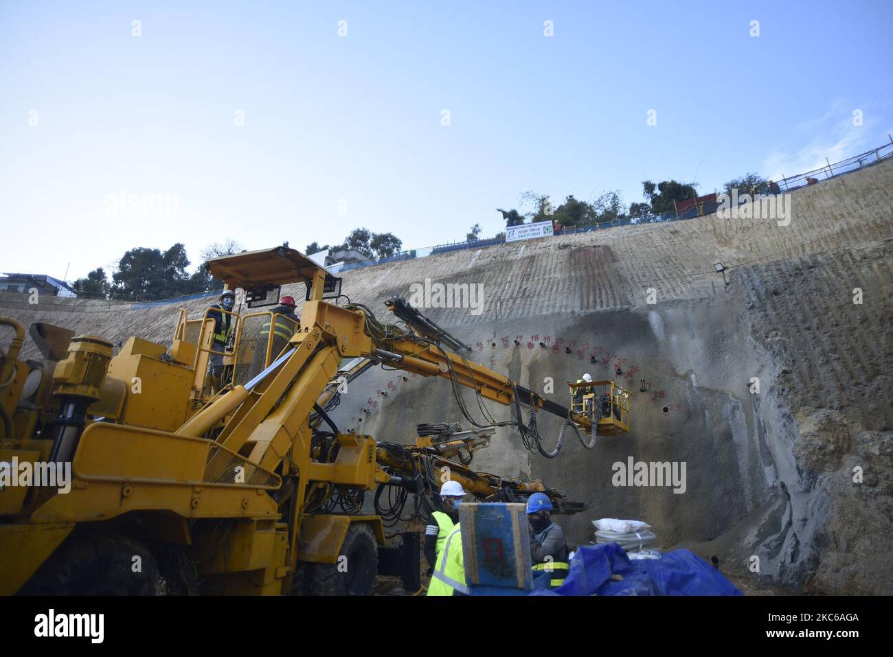 Nepalese workers gestures at the excavation site of Nepal's first road ...