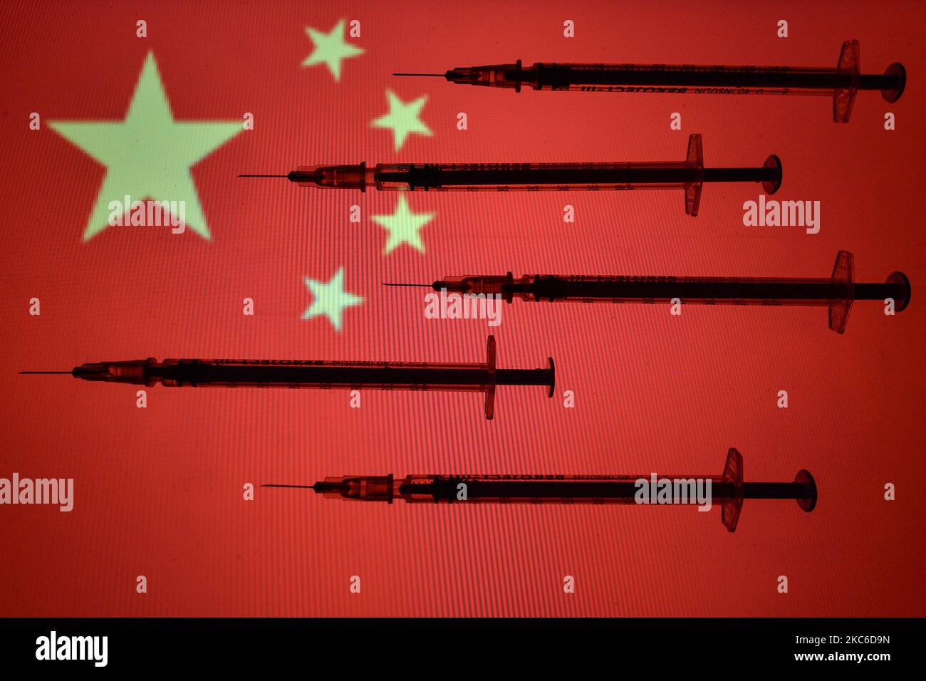 An illustrative photo showing medical syringes seen in front of the ...