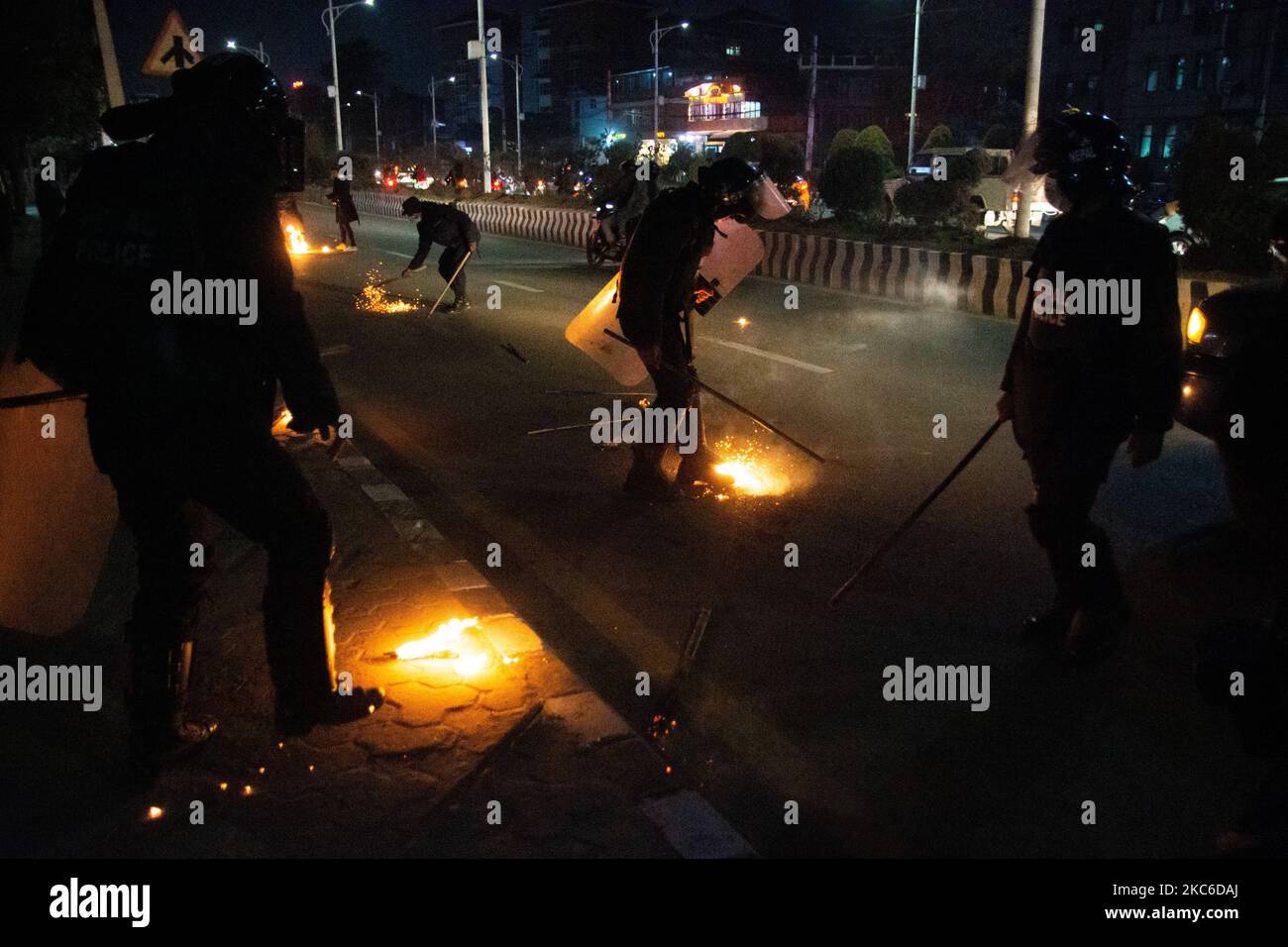 Nepalese Police extinguish lit torch during a torch protest against ...