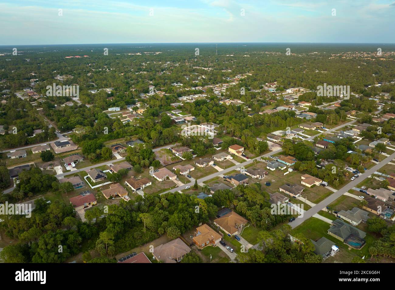Aerial landscape view of suburban private houses between green palm ...