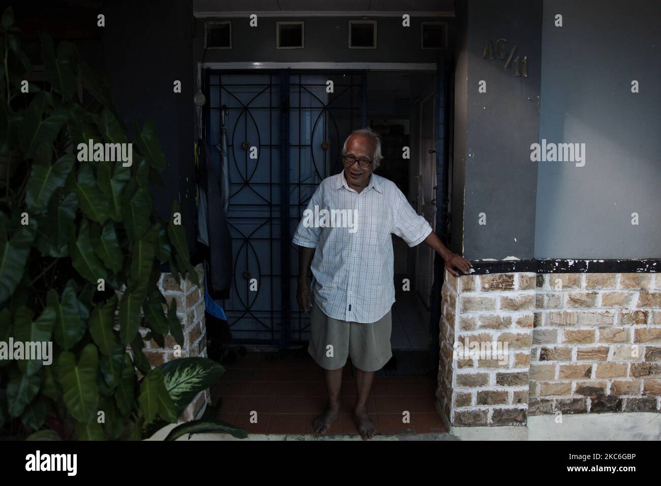 Harry Dalle (73), poses for photograph in front of his house in Bekasi ...