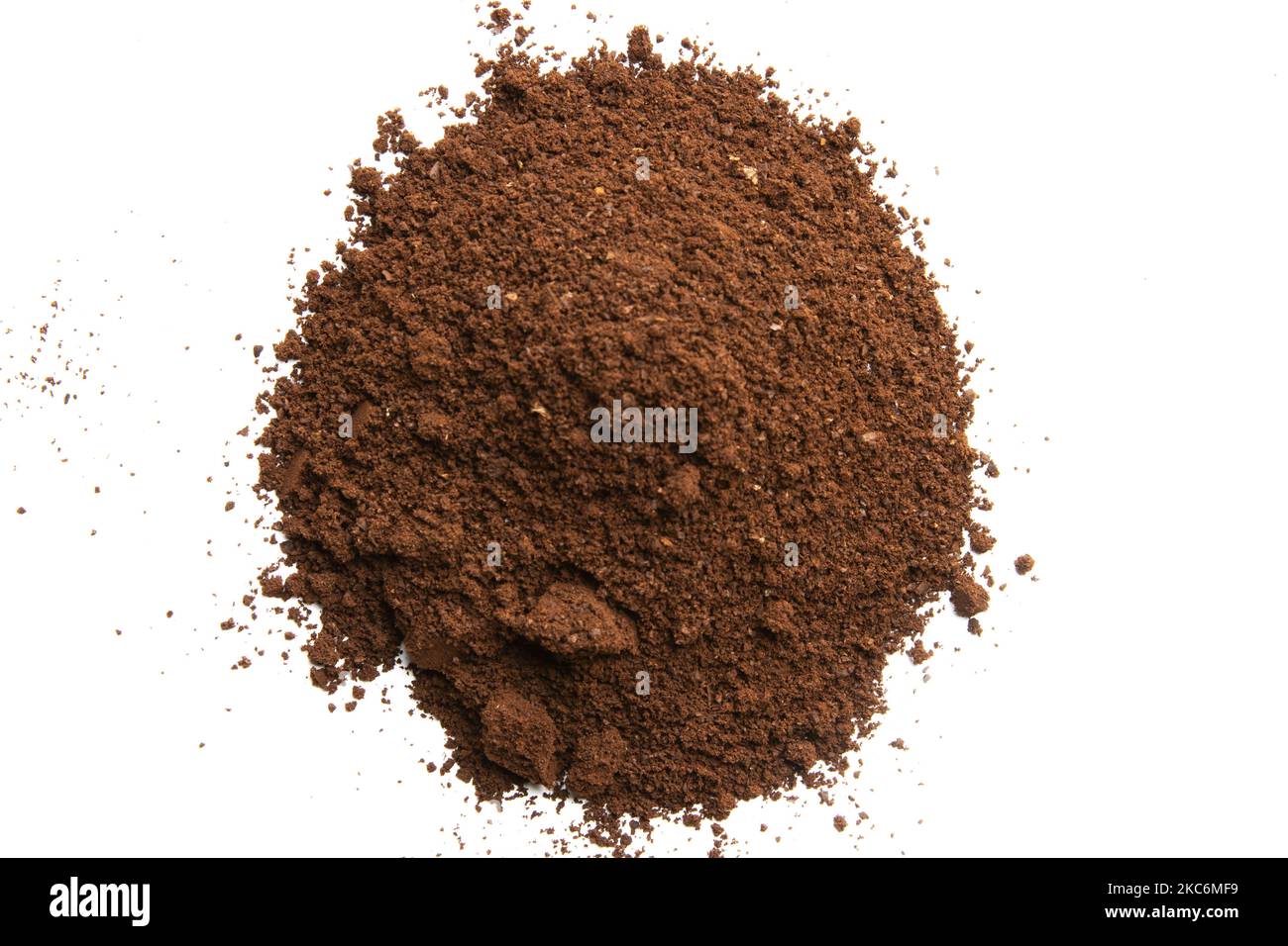 Grounded organic Arabica variety coffee from beans on white background ...