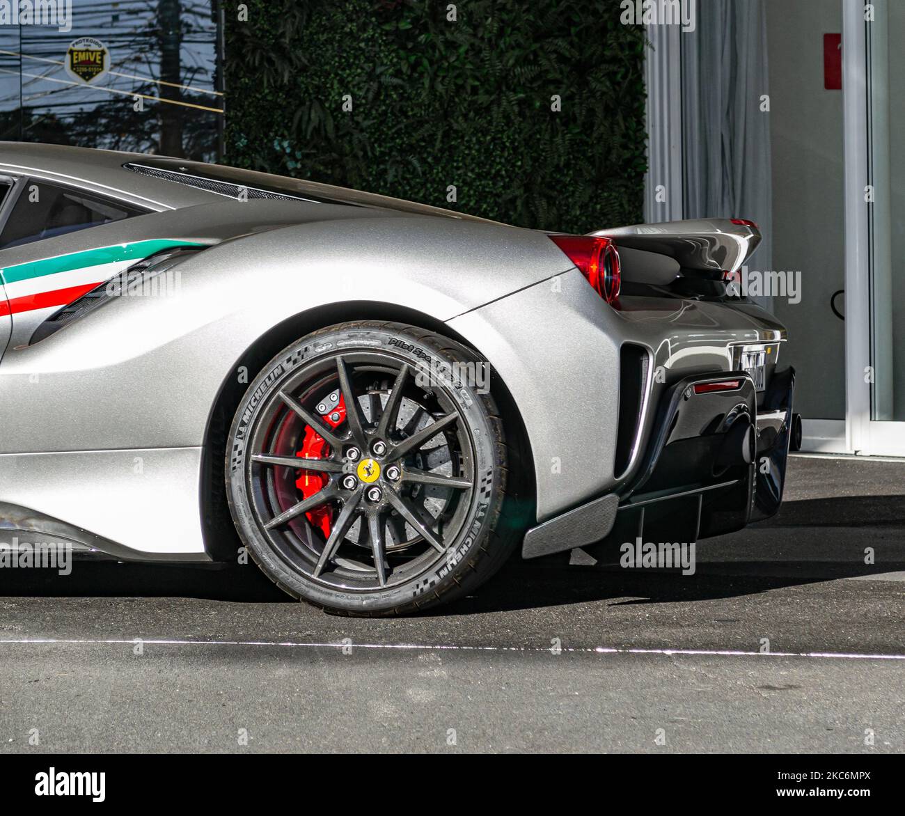 A vertical side view of a silver Ferrari 488 Pista with the Italian ...