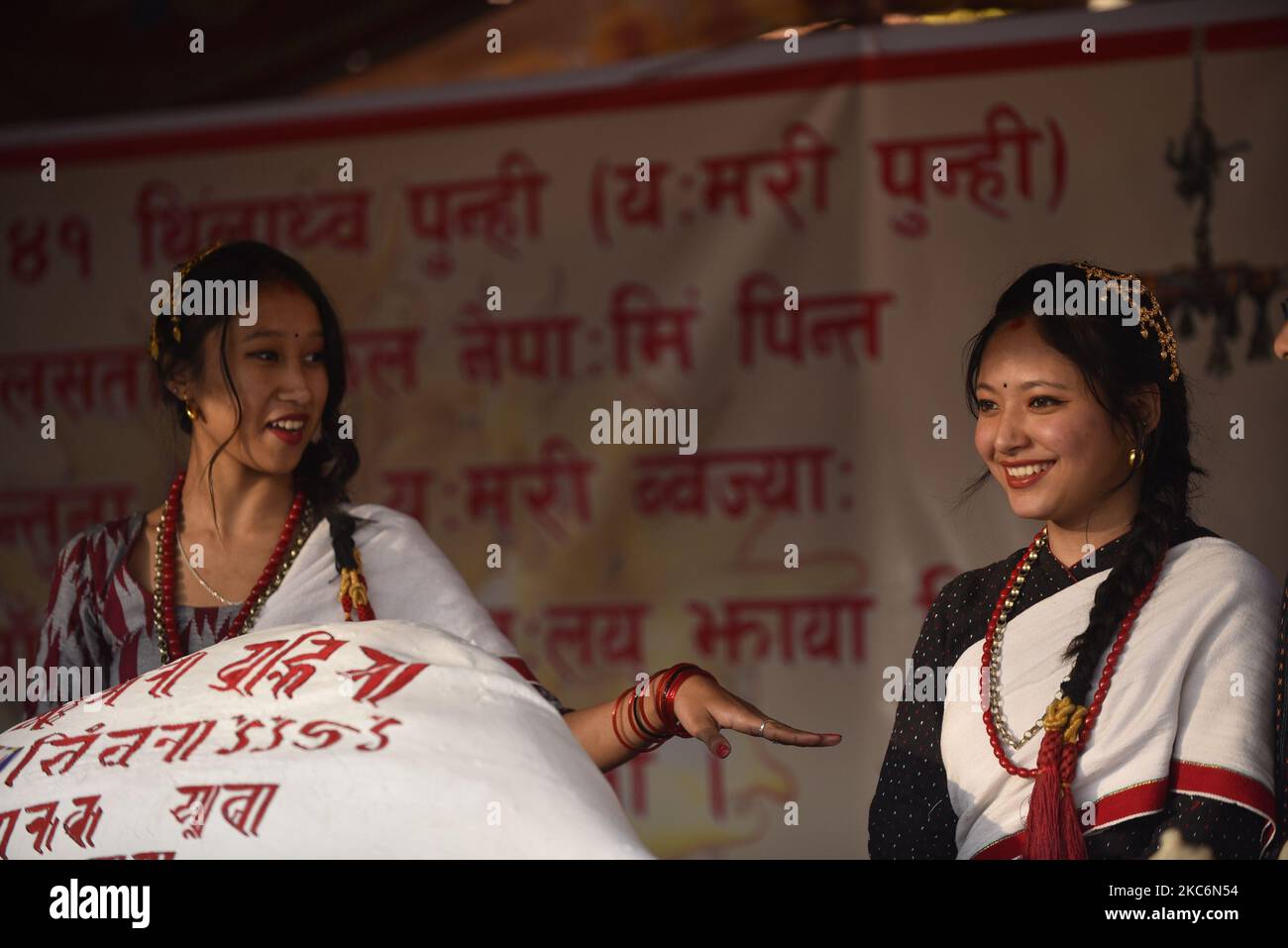 Newari girls in a traditional attire pose in a large Sample of "Yomari ...