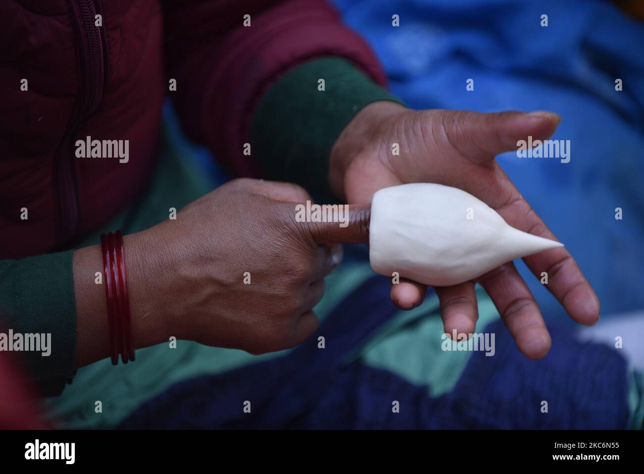 A woman making Yomari during Yomari Punhi in Kathmandu, Nepal on ...