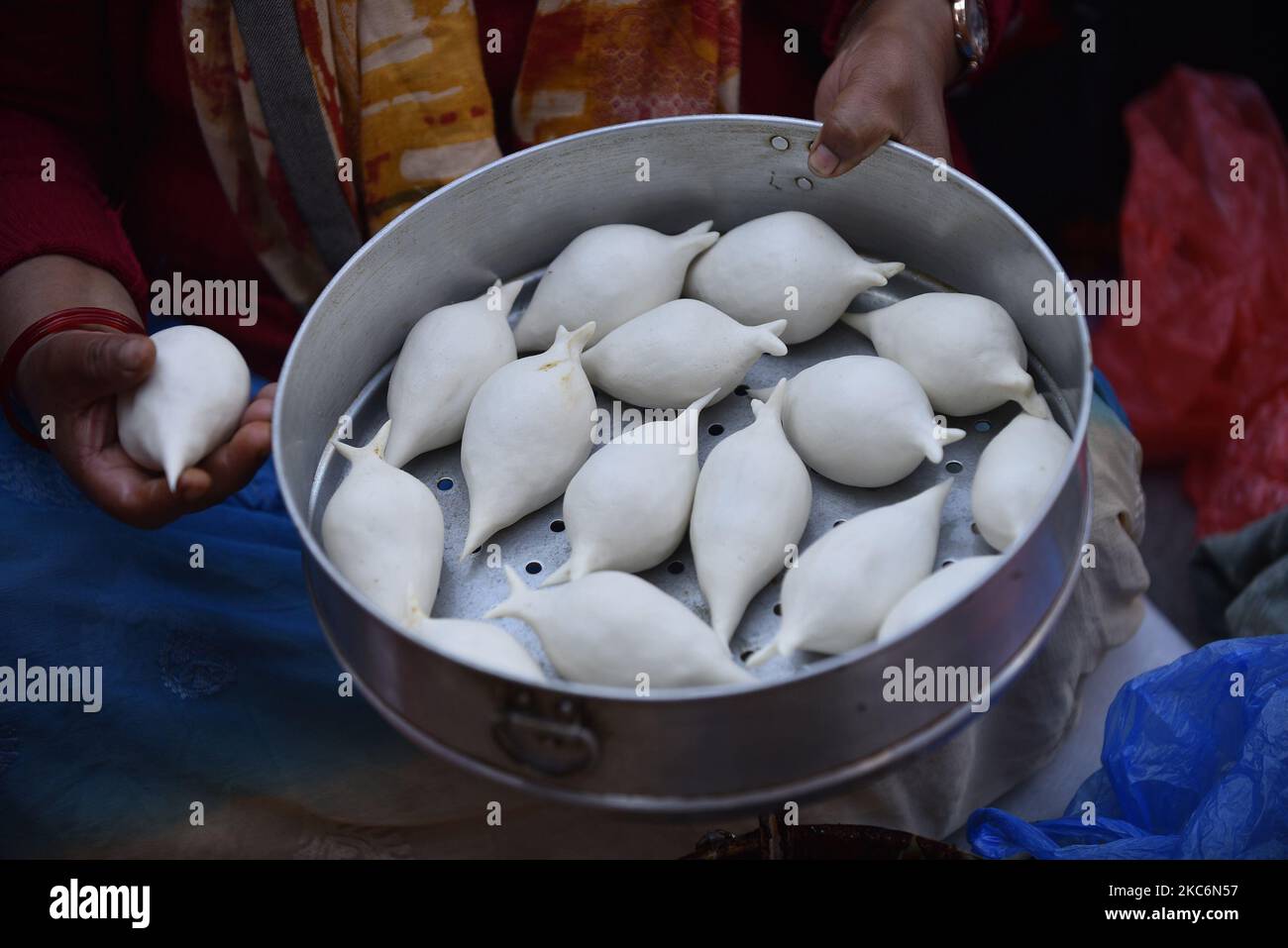 A woman shows Yomari during Yomari Punhi in Kathmandu, Nepal on ...