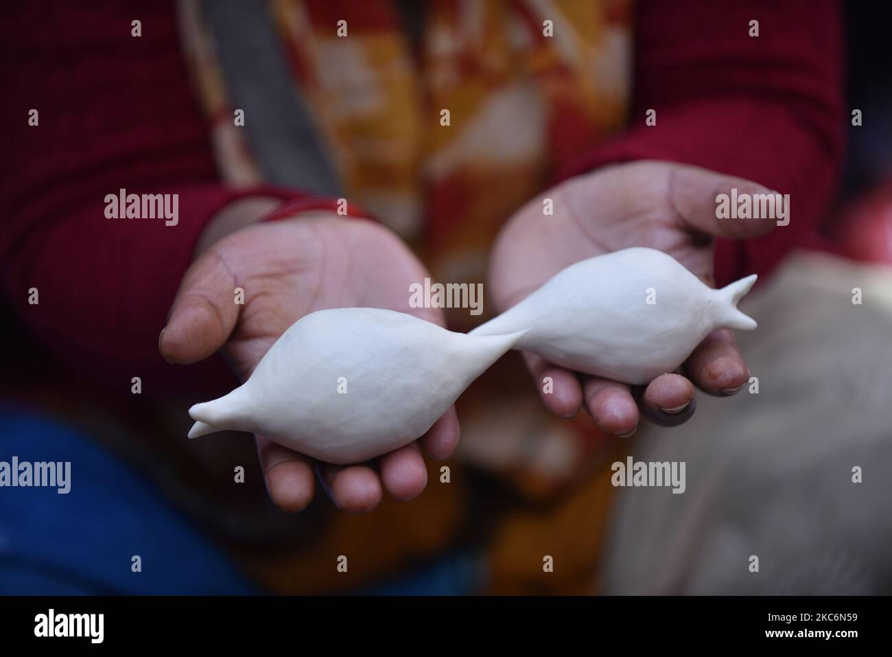 A woman shows Yomari during Yomari Punhi in Kathmandu, Nepal on ...