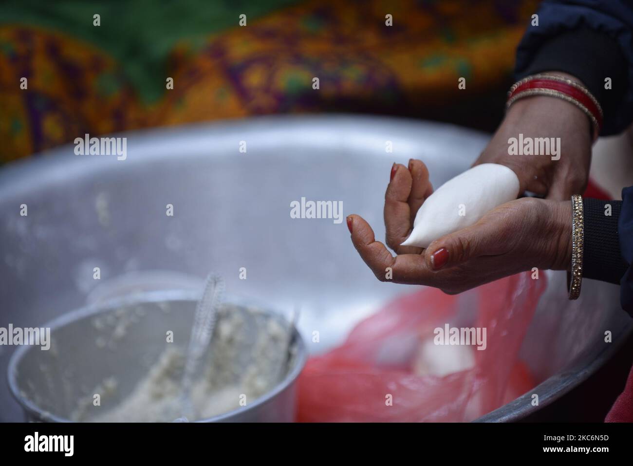 A woman making Yomari during Yomari Punhi in Kathmandu, Nepal on ...
