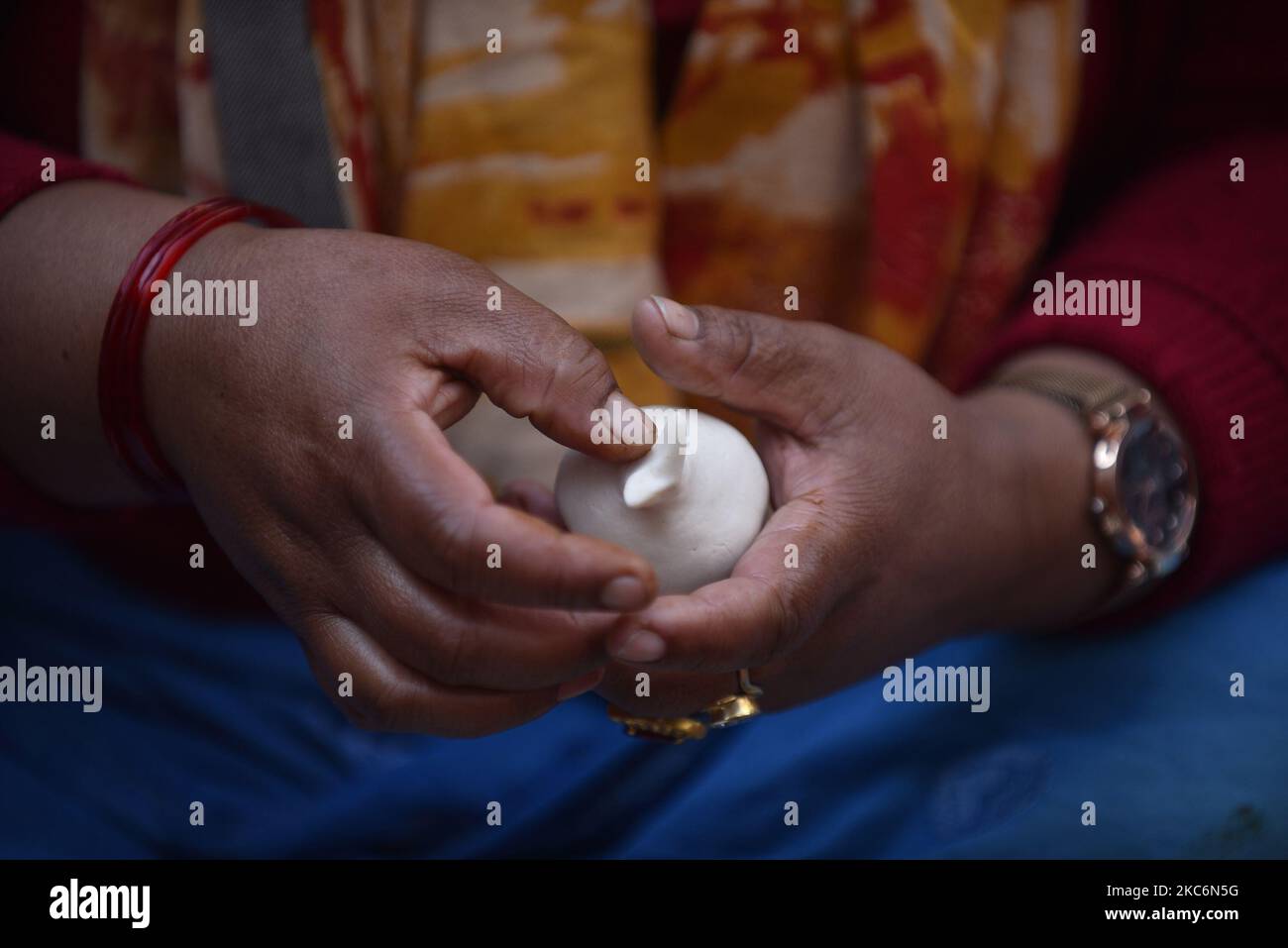 A woman making Yomari during Yomari Punhi in Kathmandu, Nepal on ...