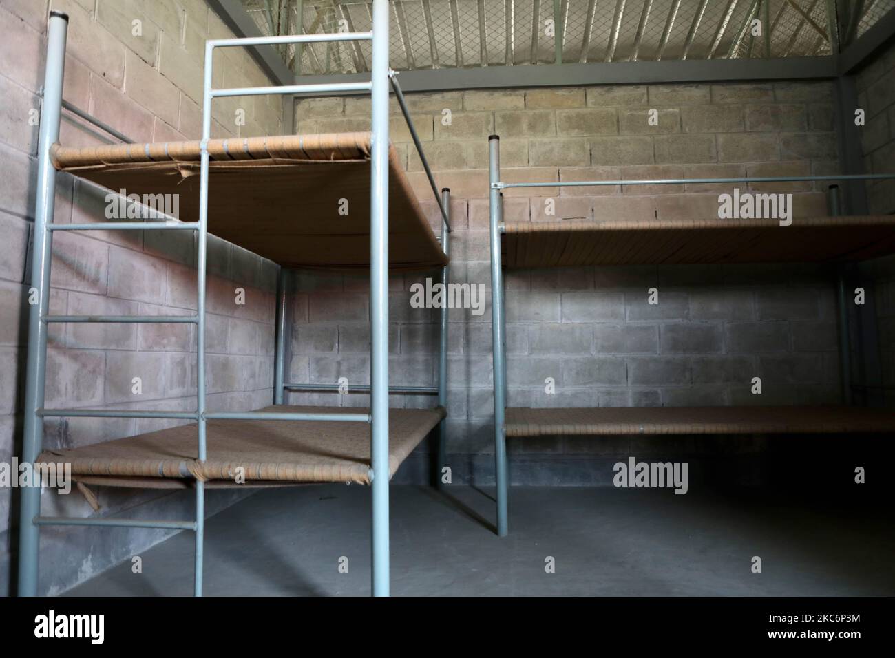 A view of a room with beds inside the tin shed concrete house at the ...