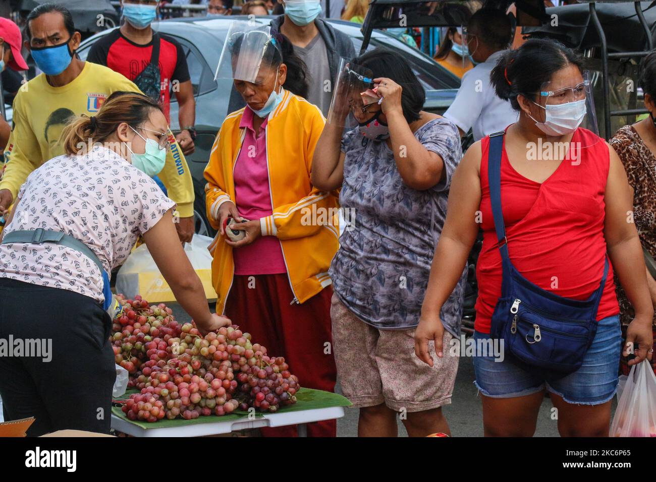 Shoppers in Antipolo Public Market wearing face masks and face shields ...