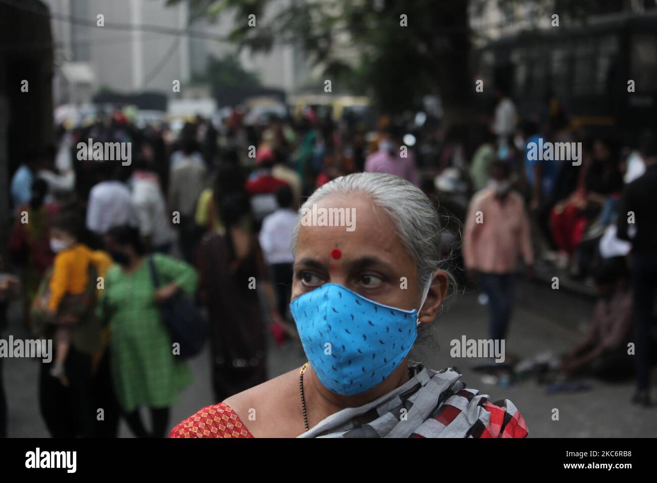 A woman wearing a protective face mask arrives to visit the Gateway of ...