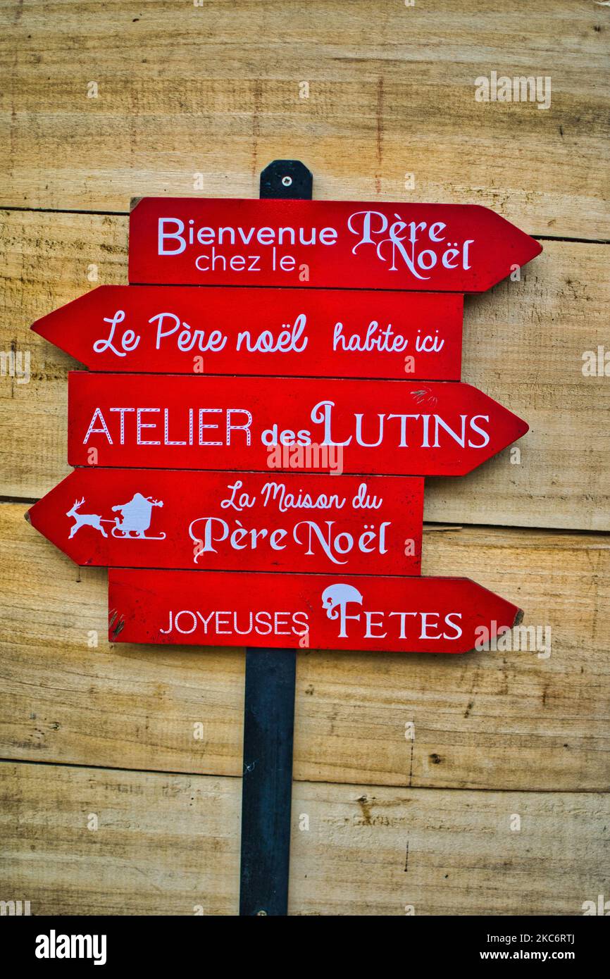 A Christmas decorated red arrows with text 'santa claus lives here ...