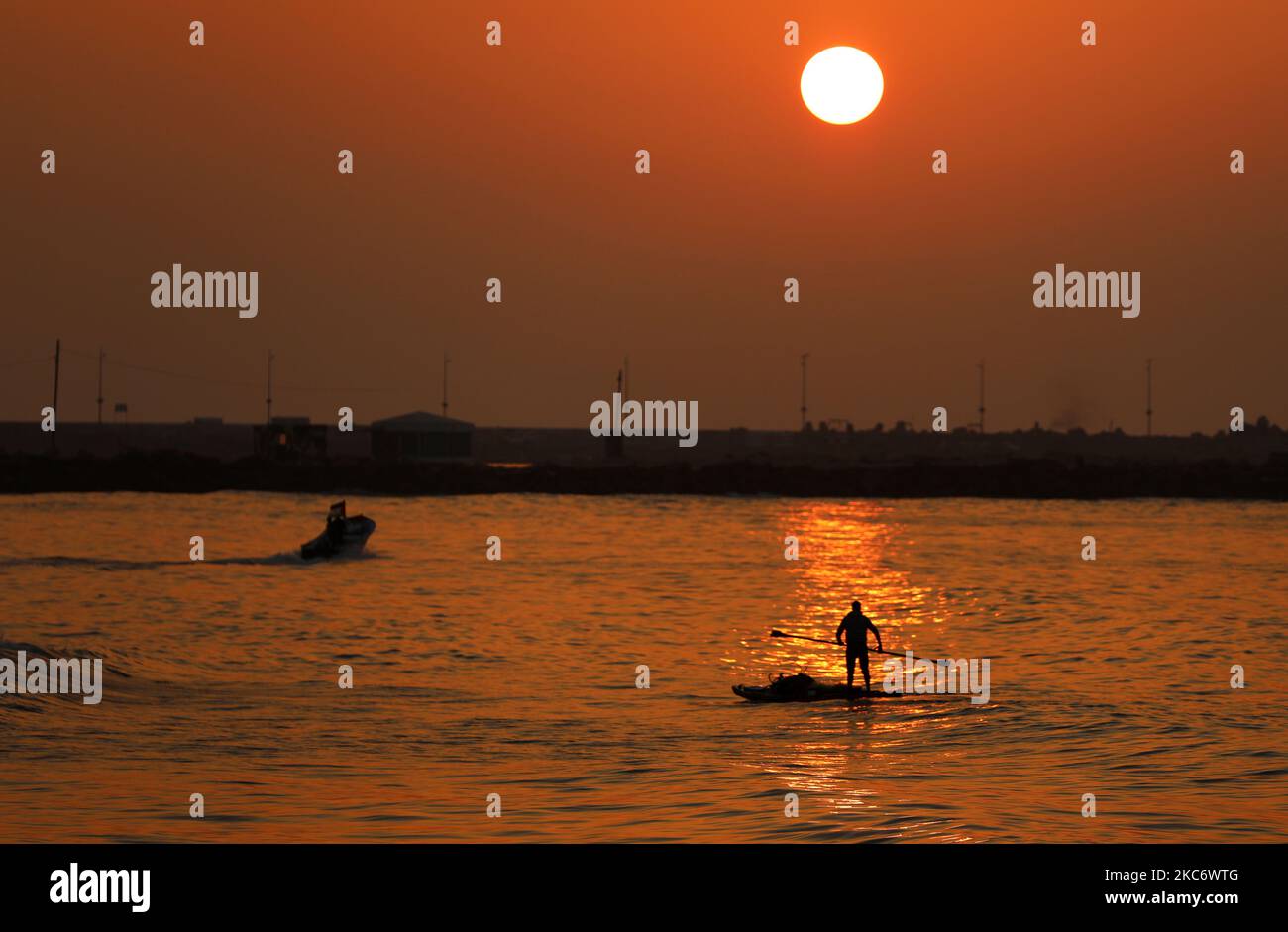 Palestinian fishermen ride a boat at the seaport of Gaza City before ...