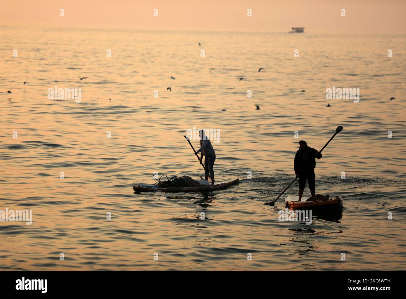 Palestinian fishermen ride a boat at the seaport of Gaza City before ...