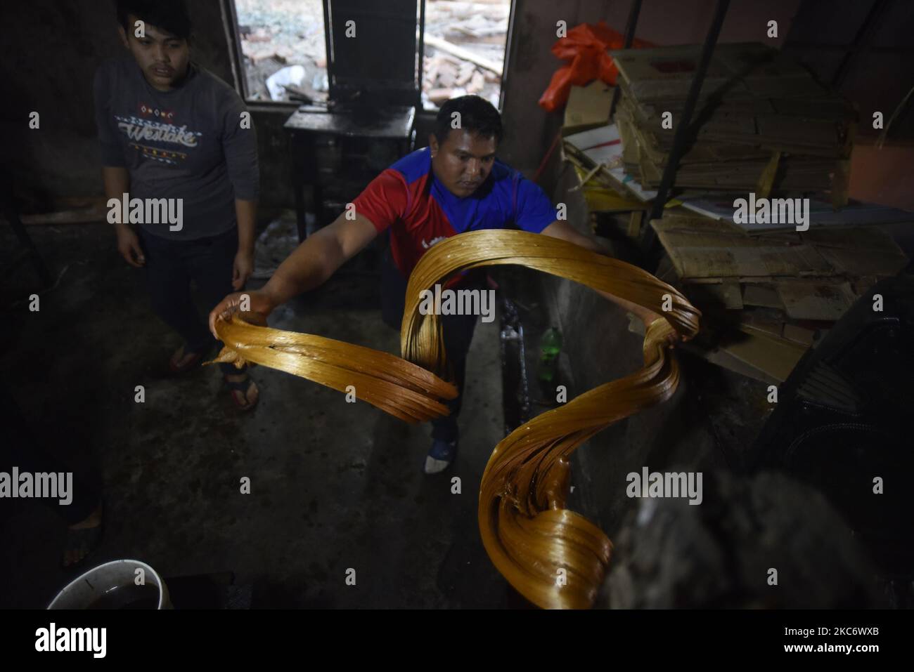 A Worker whipping semi Hard molasses to molasses Chaku at Tokha ...
