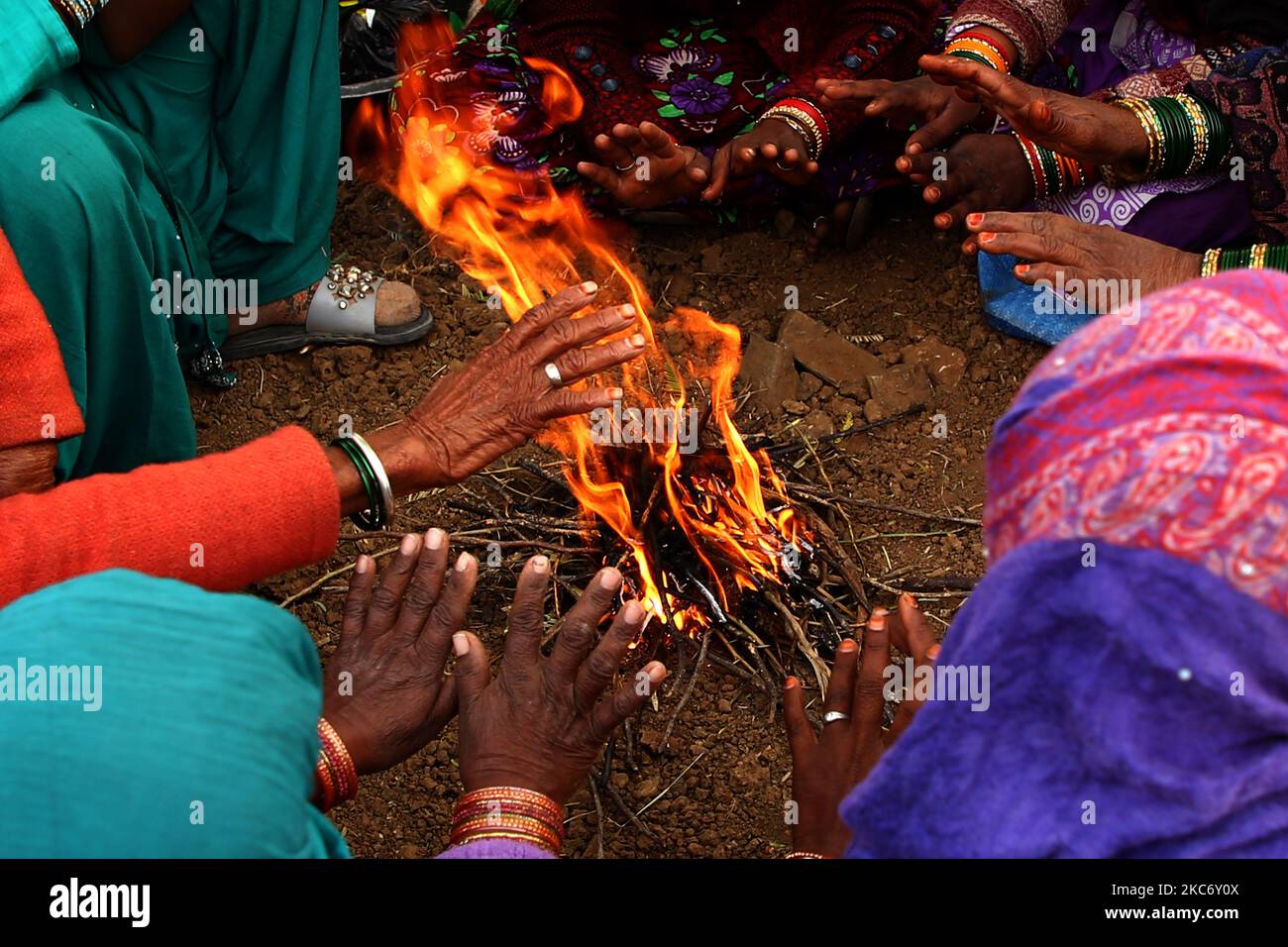 Indian Villagers warm themselves during a cold winter morning in Ajmer ...